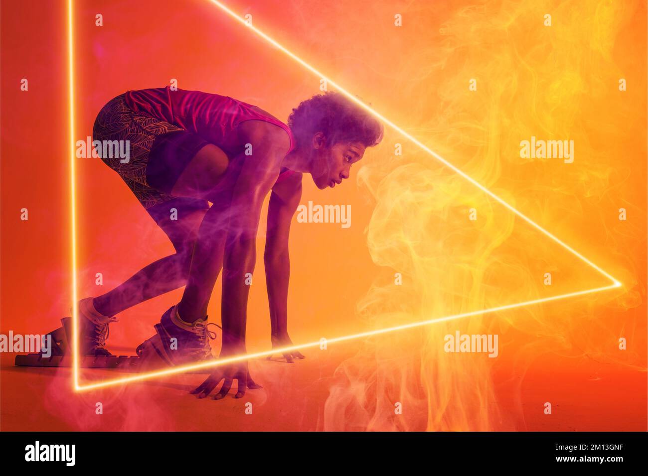 African american female athlete at starting position by illuminated ...