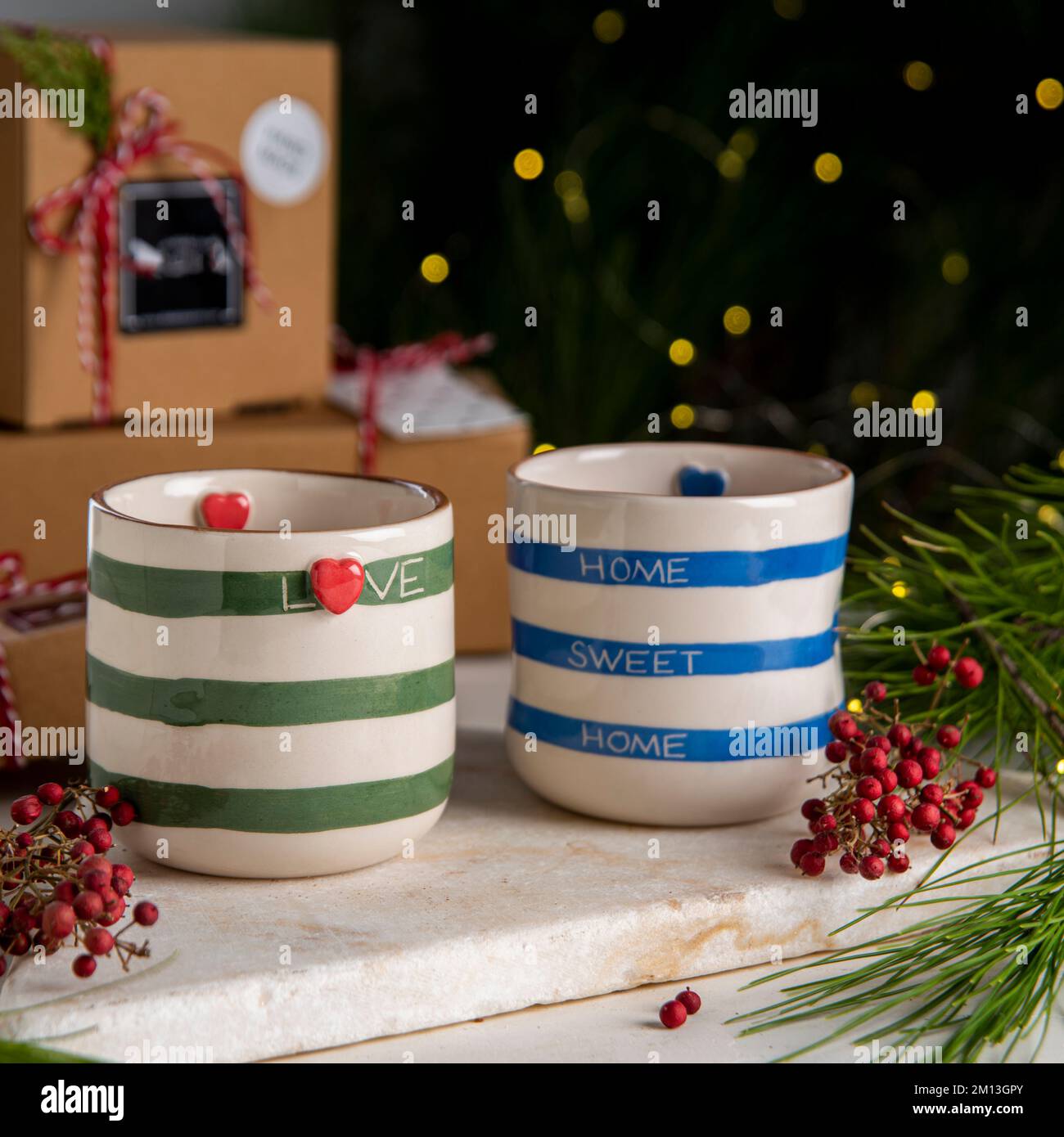 colorful ceramic coffee cups with gift boxes and christmas decoration ...