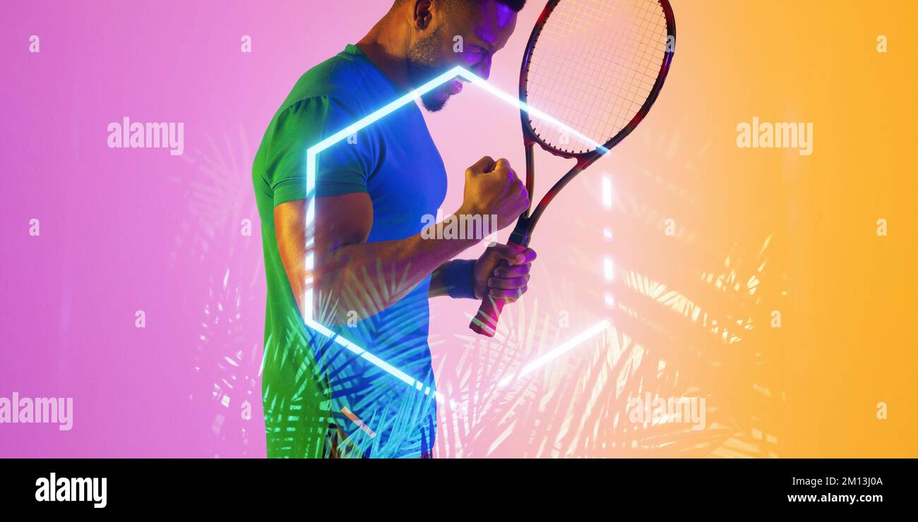 Happy african american male player holding racket shaking fist by ...