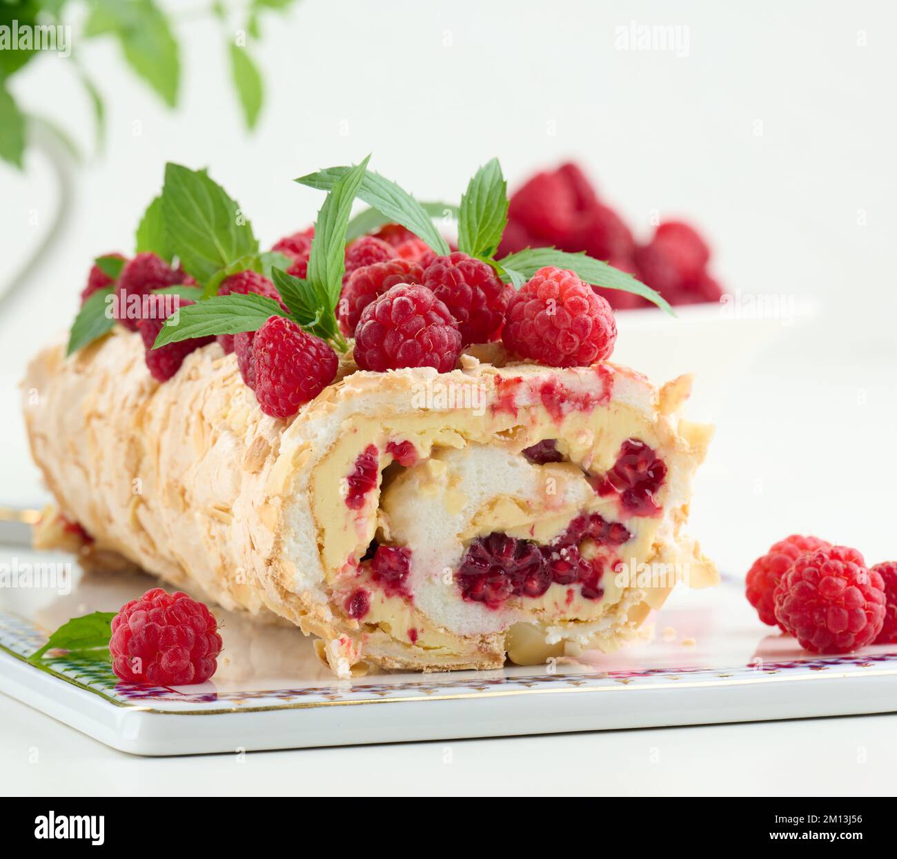 Baked meringue roll with cream and fresh red raspberry, white ...