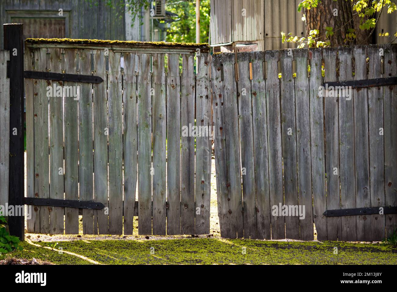 The old rickety wooden gate and the sun's rays penetrating through the ...