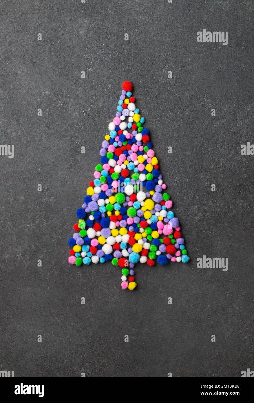 Creative Christmas tree made from colorful fluffy balls on black ...