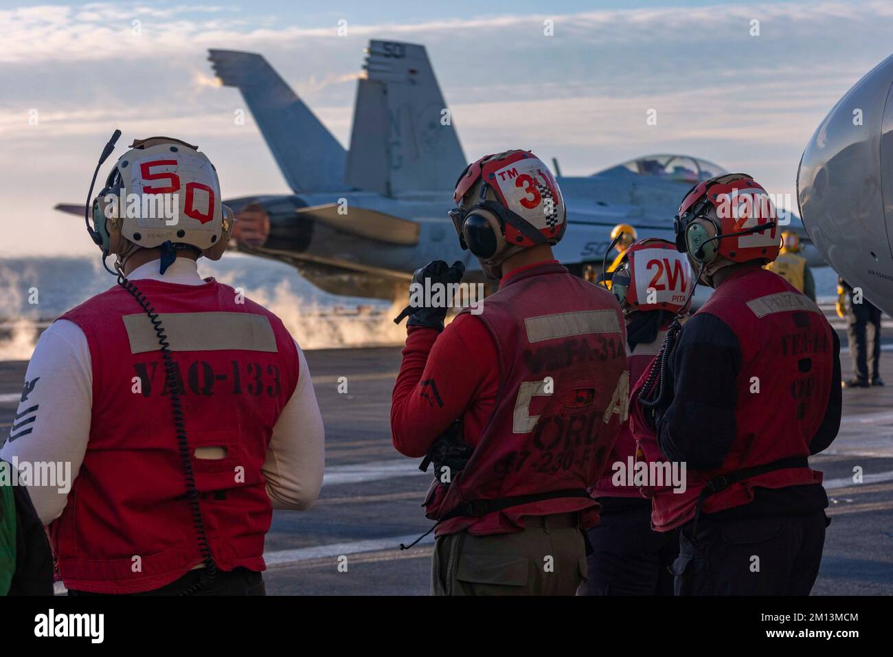 Marines and Sailors observe flight operations on the flight deck aboard ...