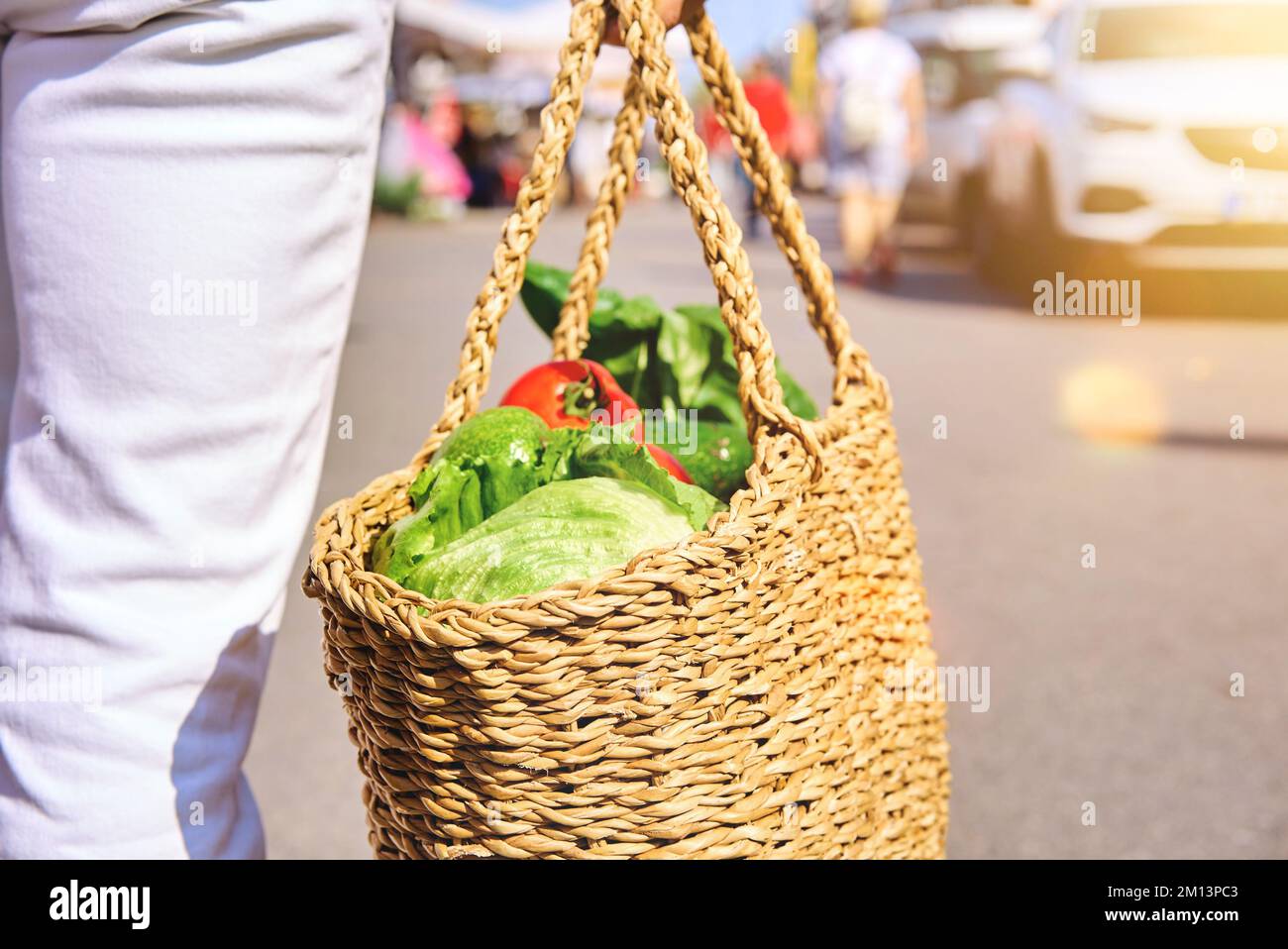 Hands carrying shopping basket with vegetables in street Stock Photo ...