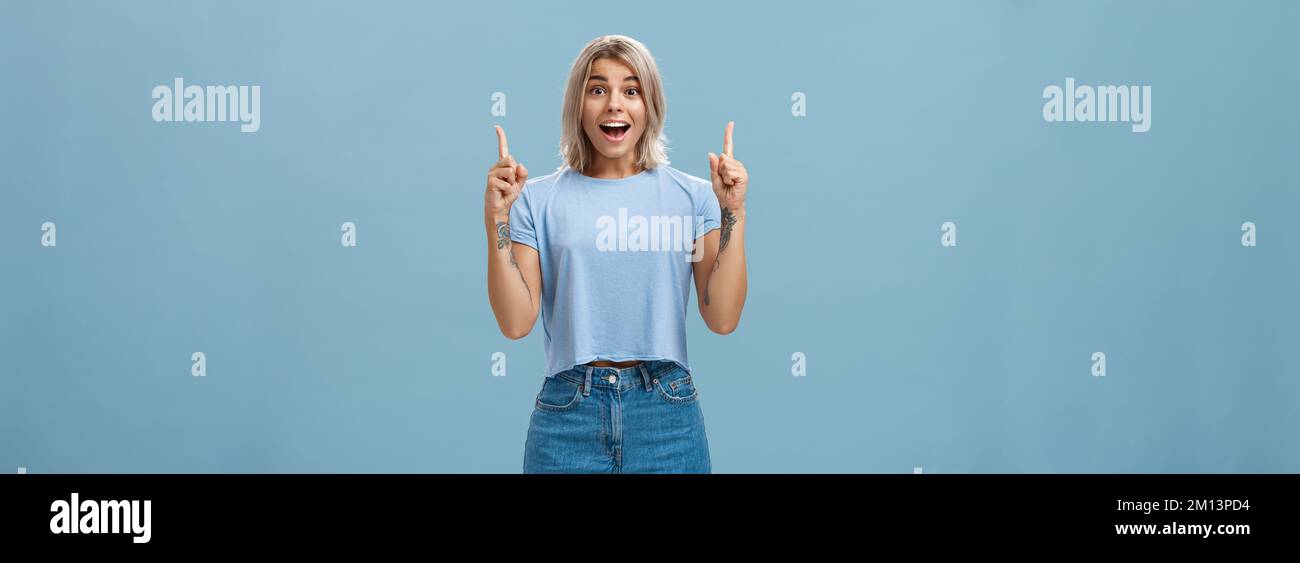 Waist-up shot of impressed enthusiastic creative blonde woman in trendy ...