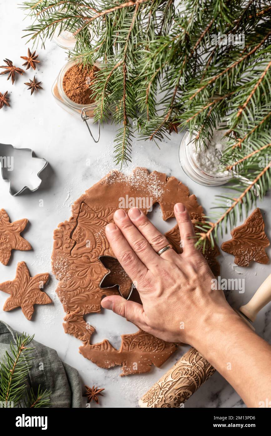 Man's hands cut shapes and make cookies. Making Christmas cookies. Top ...