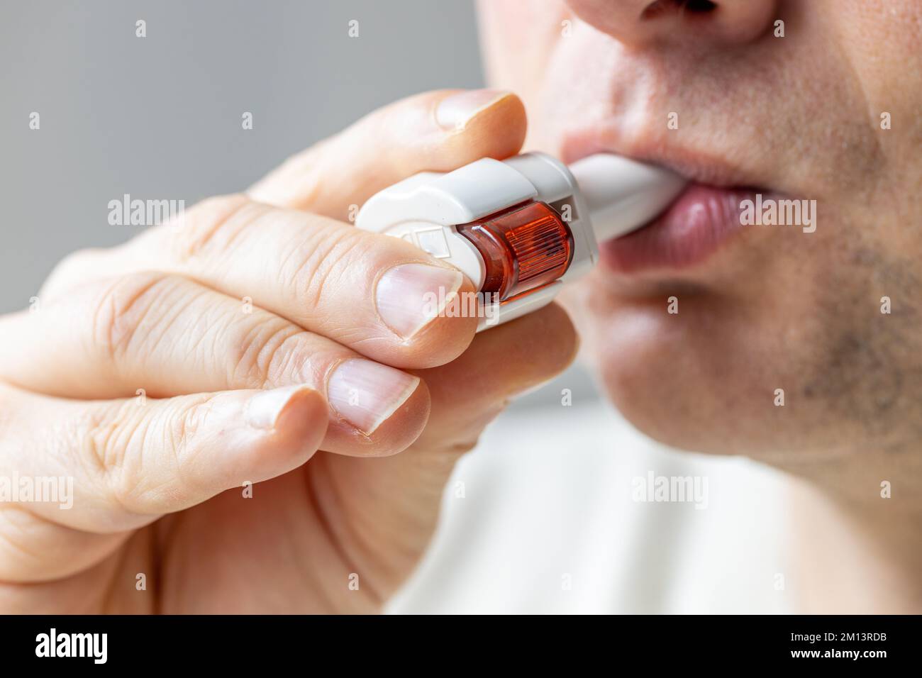 Taking medication with inhaler, Help with breathing and healing. A man ...