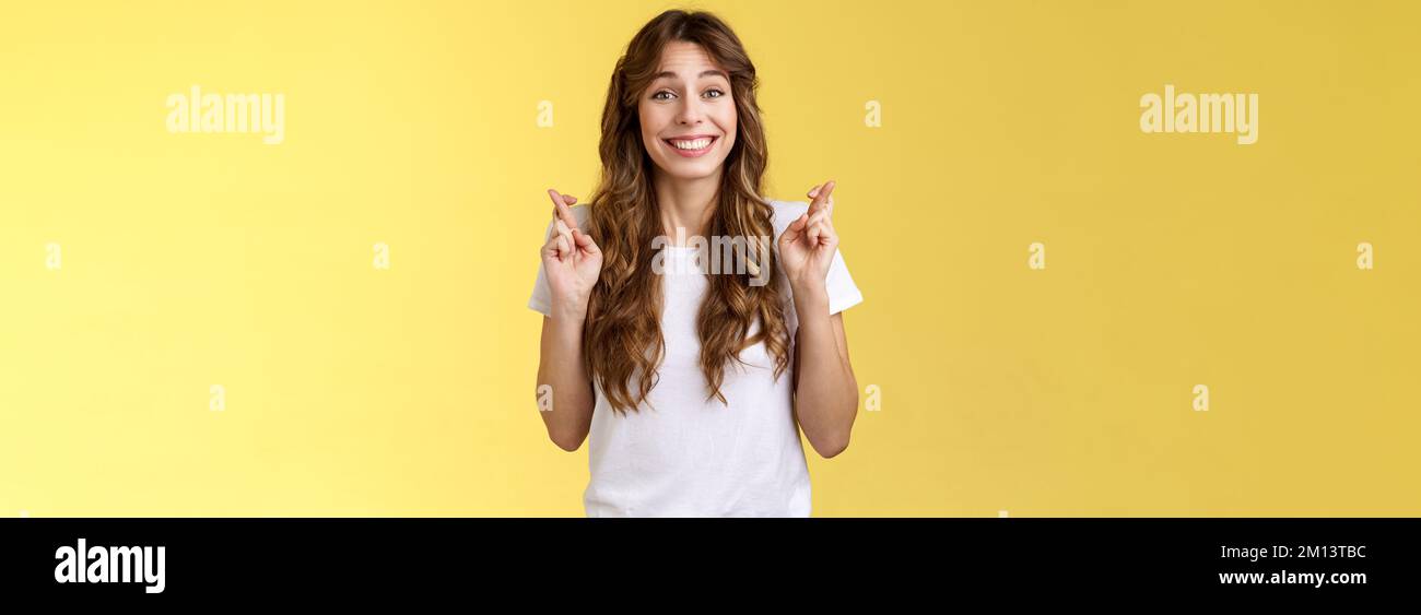 Silly hopeful excited attractive caucasian girl curly haircut wishing ...