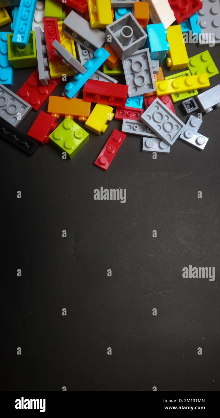 Plastic toy blocks on black background Stock Photo - Alamy