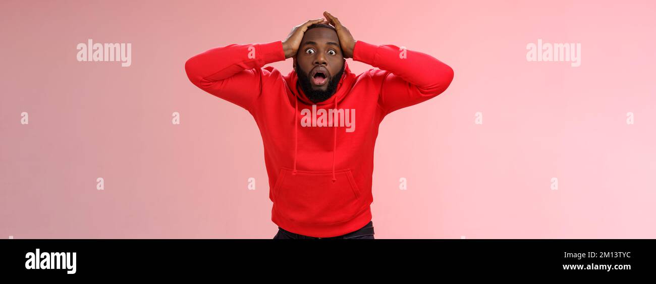 Impressed concerned black guy standing stupor worried grab head shocked ...