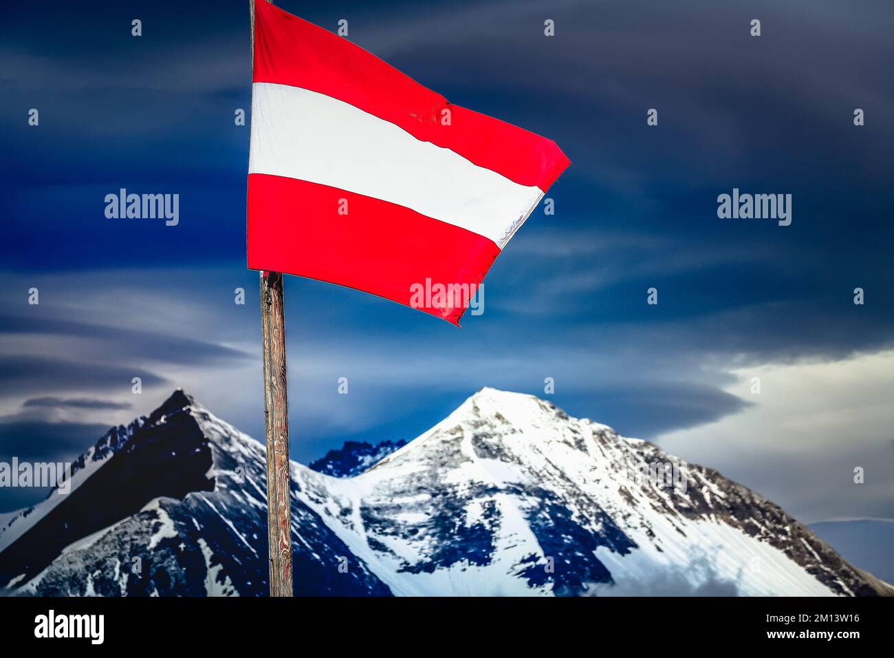 Austrian flag in Grossglockner National Park, snowcapped alps at ...