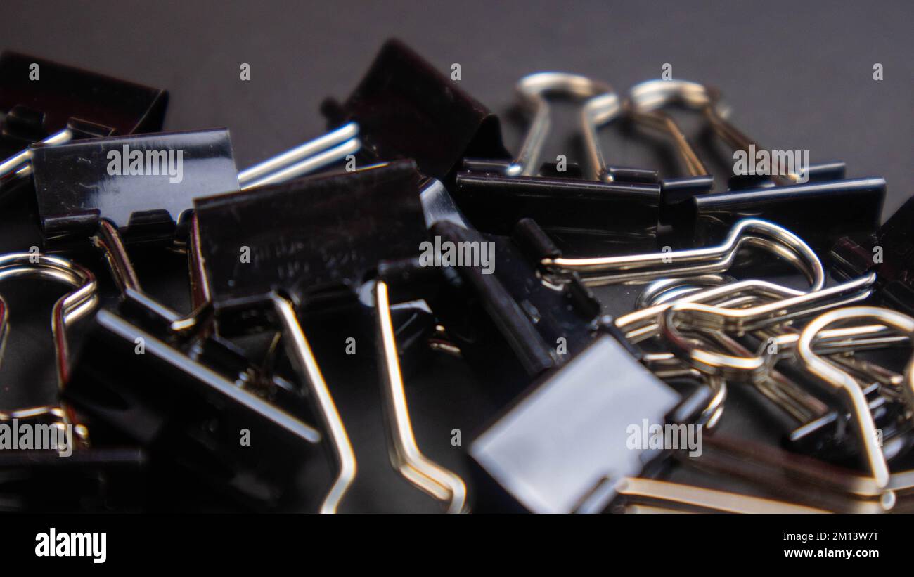 black paper clip on black background Stock Photo - Alamy