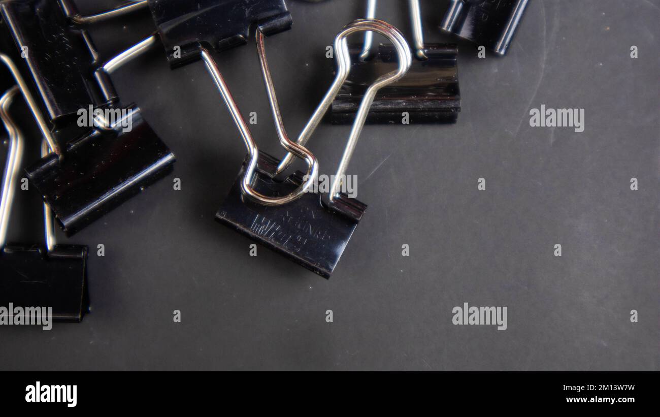 black paper clip on black background Stock Photo - Alamy