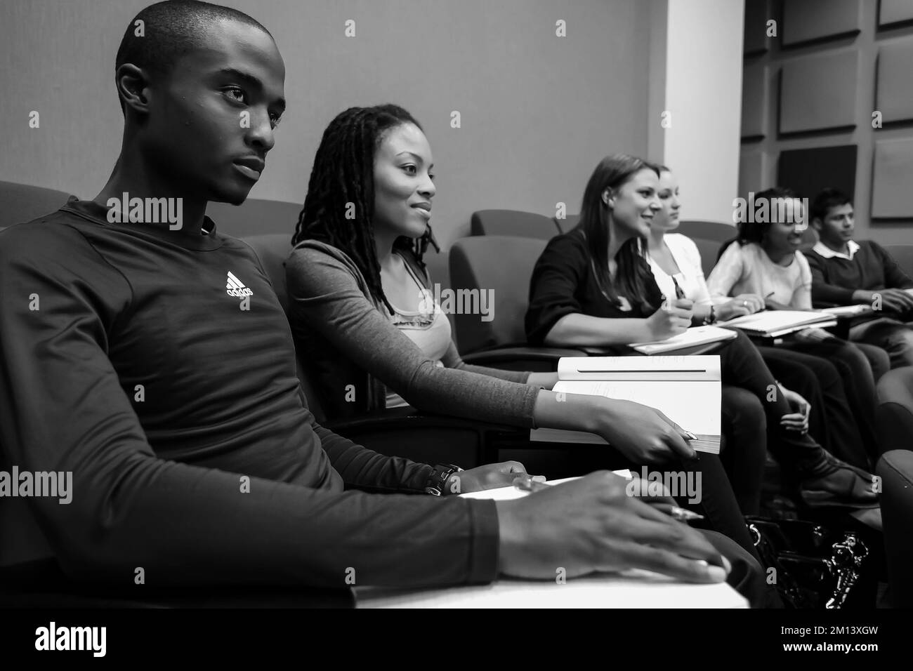 A group of diverse students in a classroom at the College campus in ...