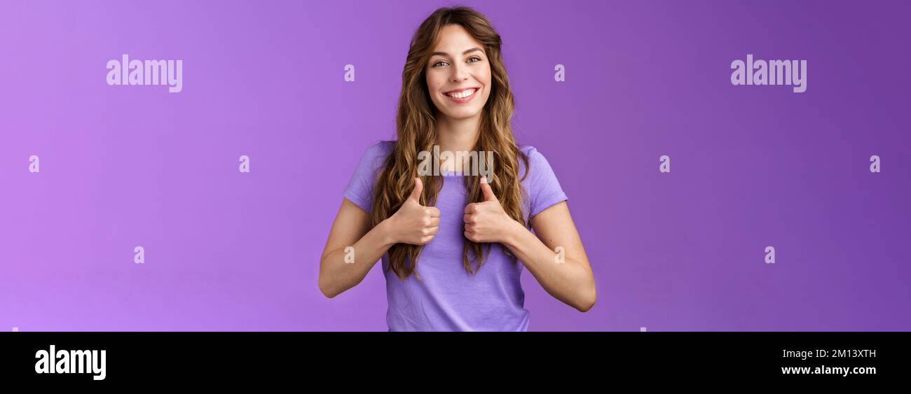 Upbeat positive attractive cheerful curly girl show thumbs up approval ...