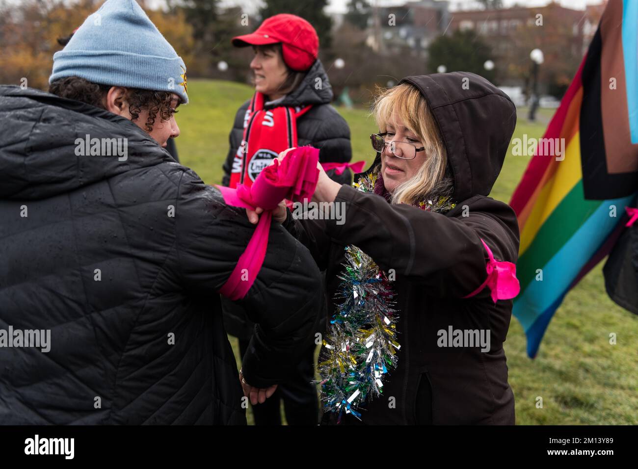 Seattle, USA. 9th Dec, 2022. People gather in the pouring rain at a ...