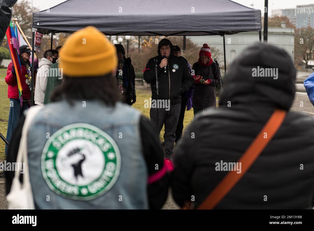 Seattle, USA. 9th Dec, 2022. People gather in the pouring rain at a ...