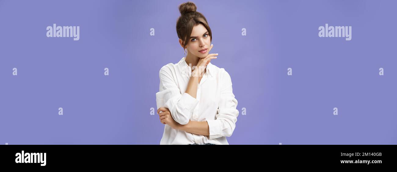 Portrait of tender and feminine stylish woman in white blouse posing ...