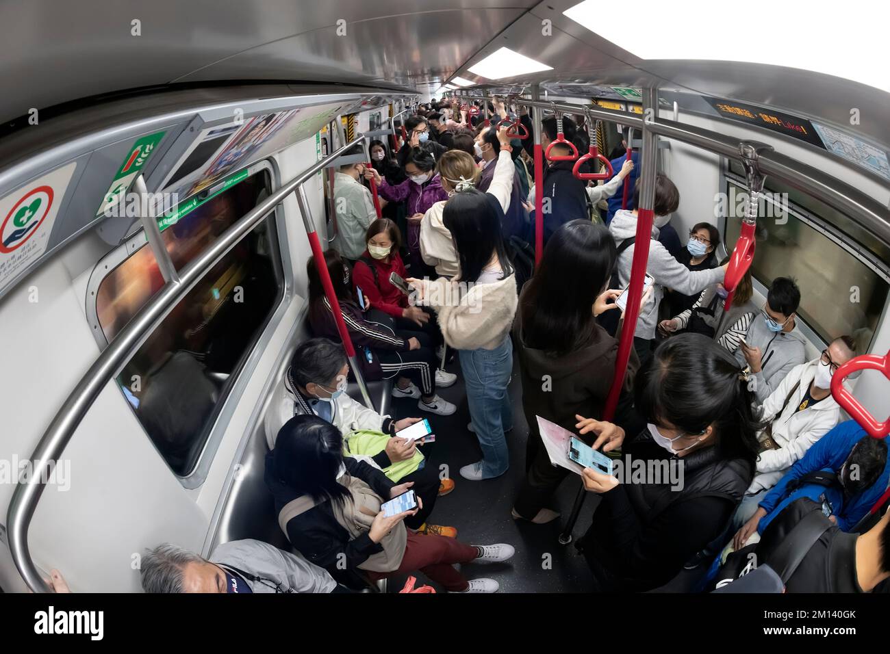 Passengers using mobile phones on the Hong Kong MTR subway, Hong Kong, China Stock Photo - Alamy