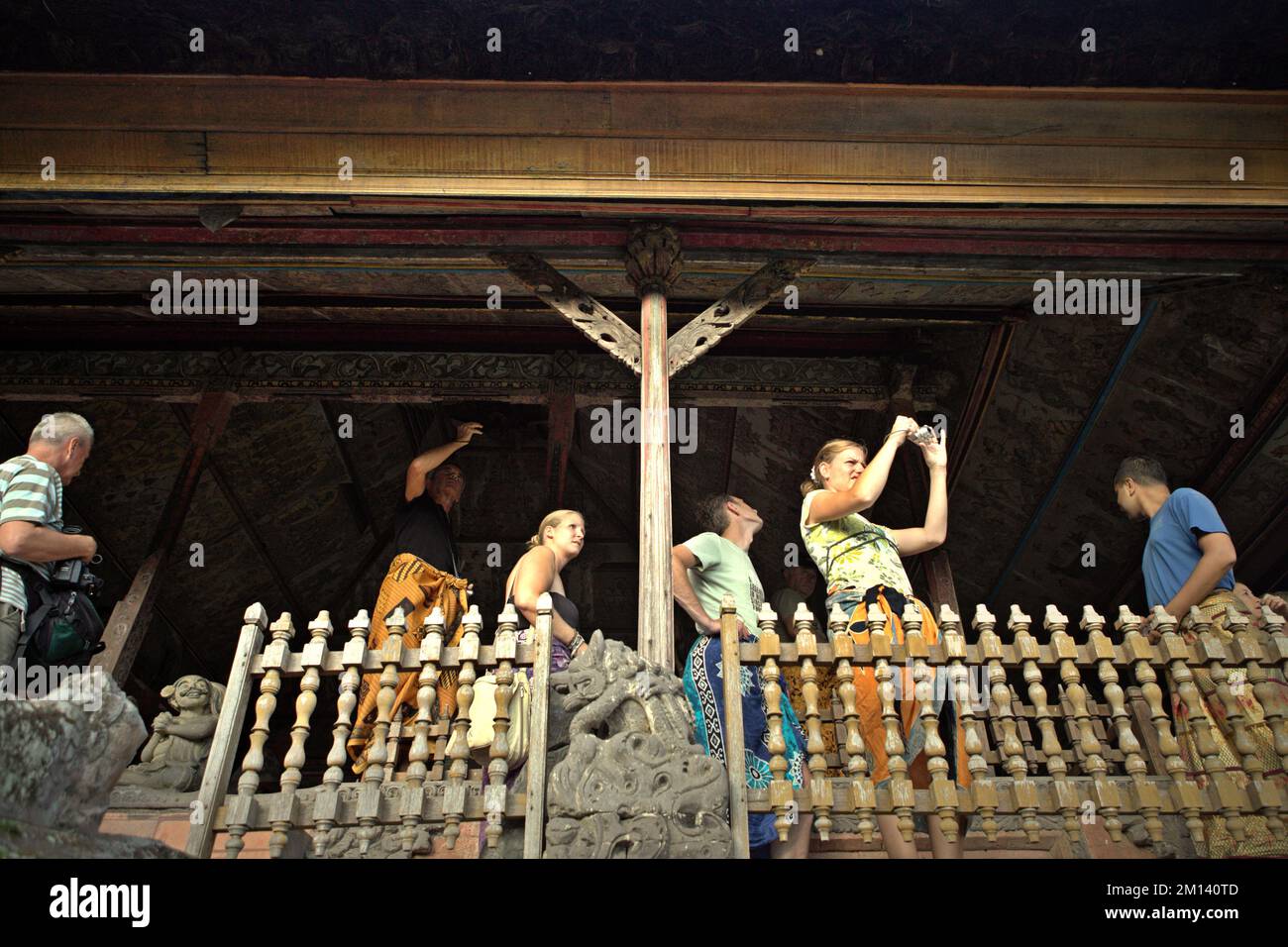 Visitors at Kertha Gosa, an iconic pavilion that its ceiling showcasing ...