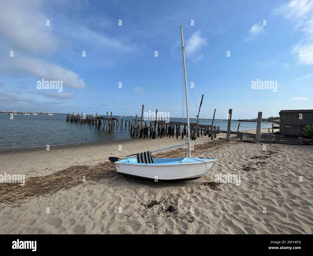 A small sailboat stranded on the beach in Cape Cod Massachusetts Stock ...