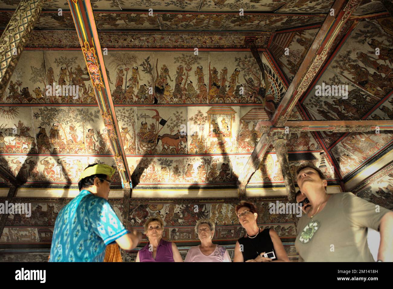 Visitors at Kertha Gosa, an iconic pavilion that its ceiling showcasing ...