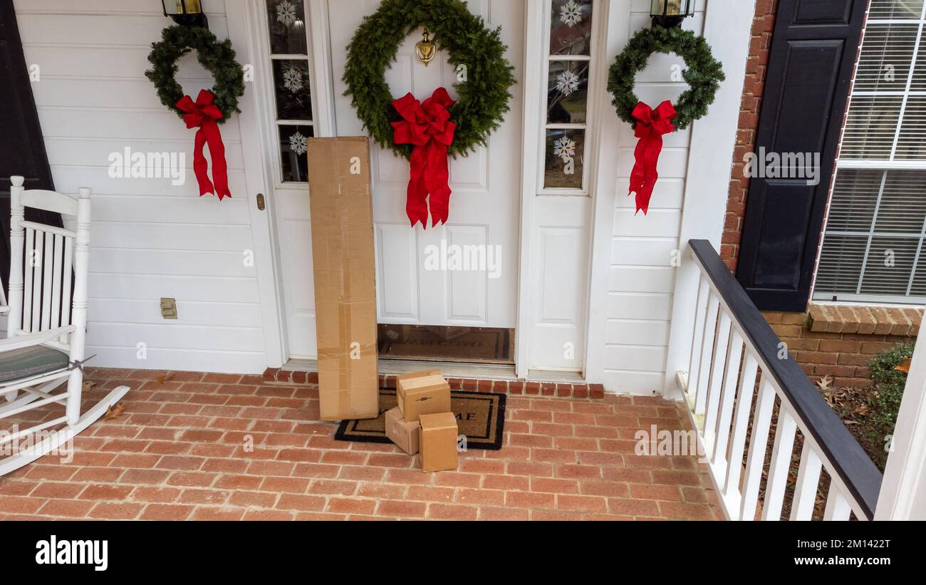 Shipping packages on front porch of home during holiday season Stock ...