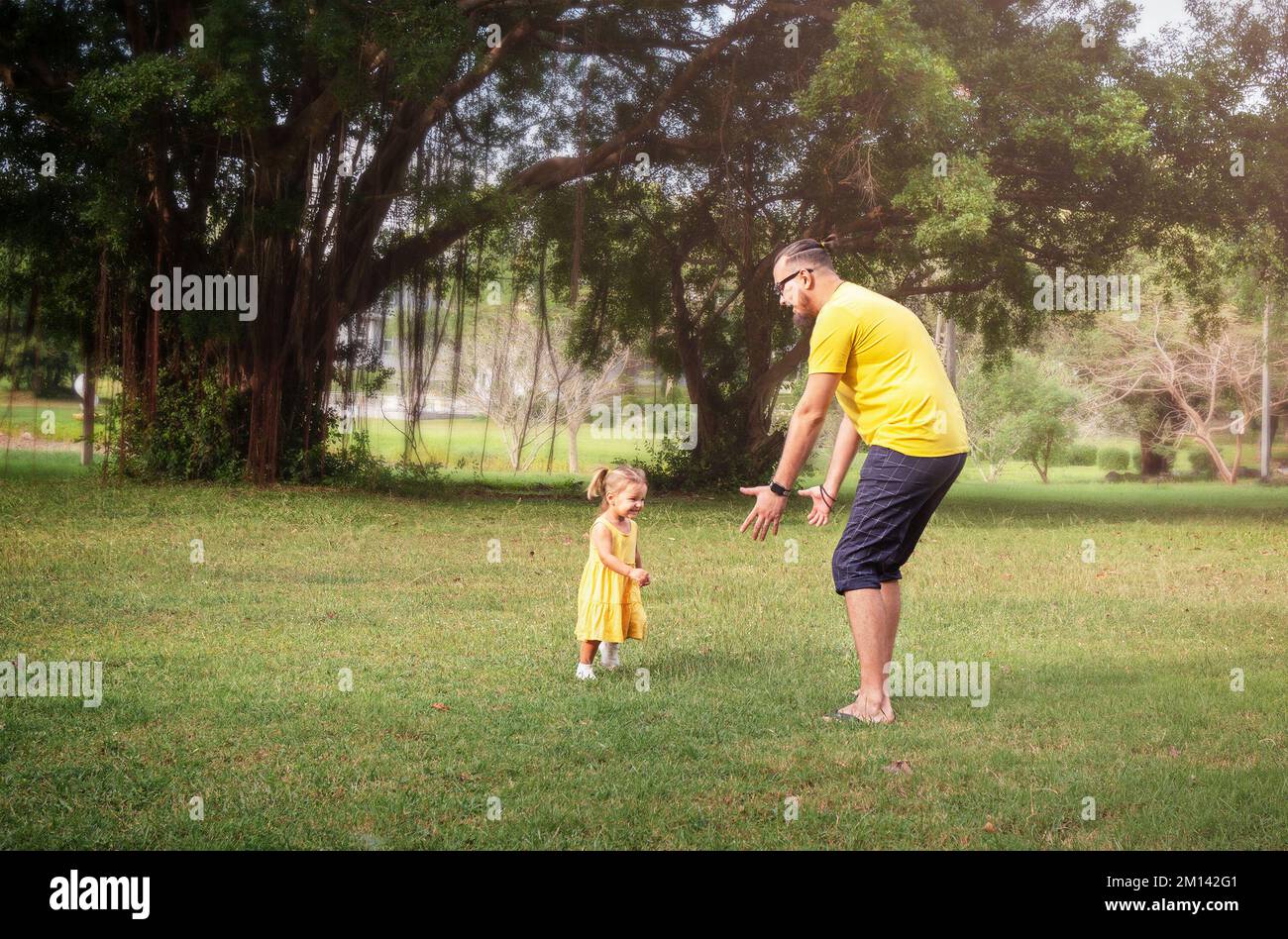 Dad and child running on the grass outdoor Stock Photo - Alamy