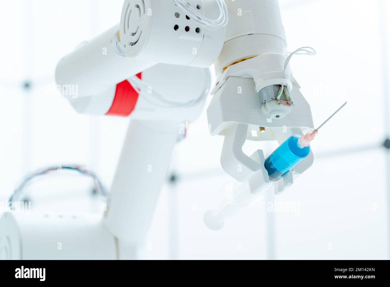 Robotic arm holding syringe Stock Photo - Alamy