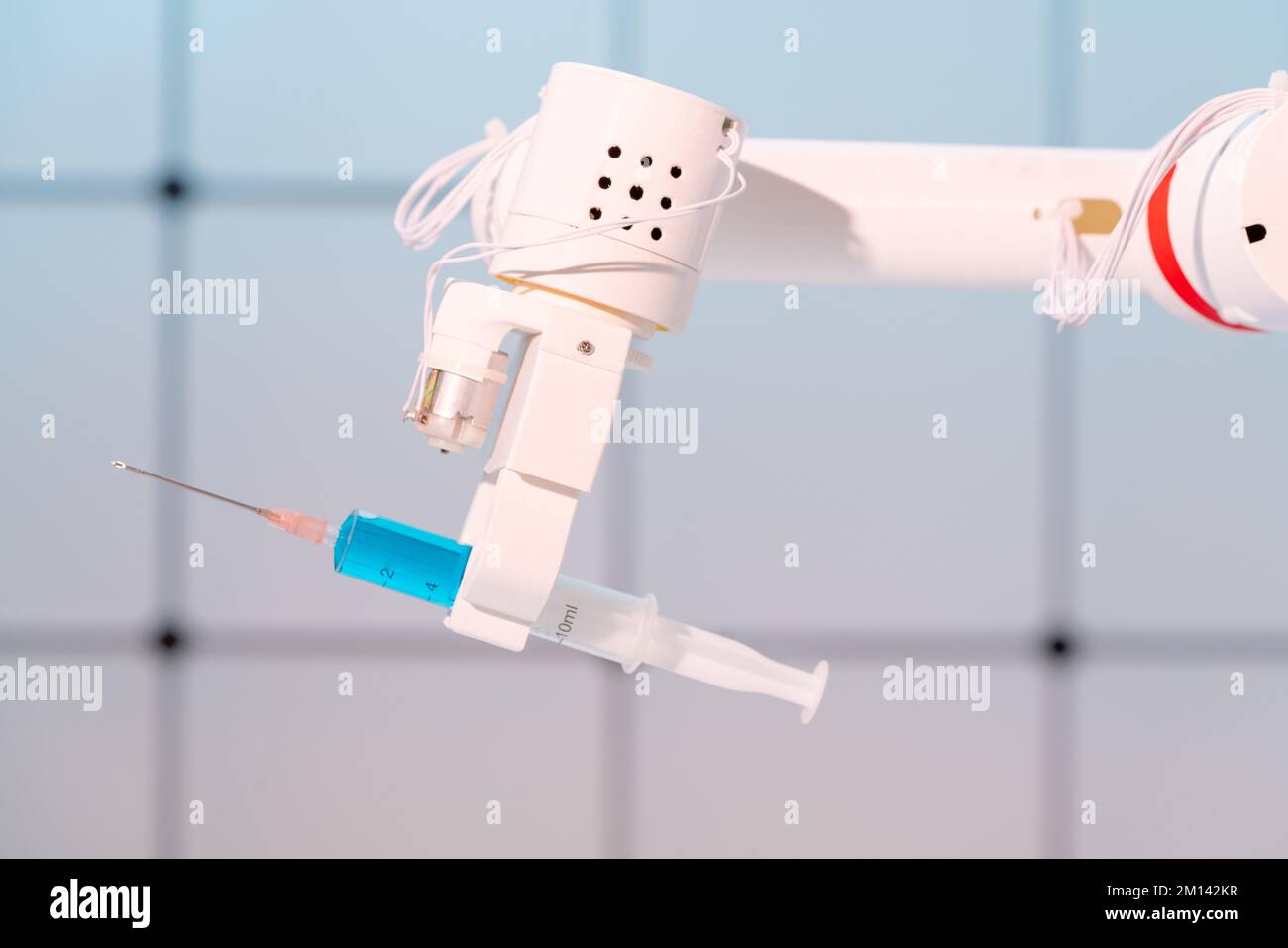 Robotic arm holding syringe Stock Photo - Alamy