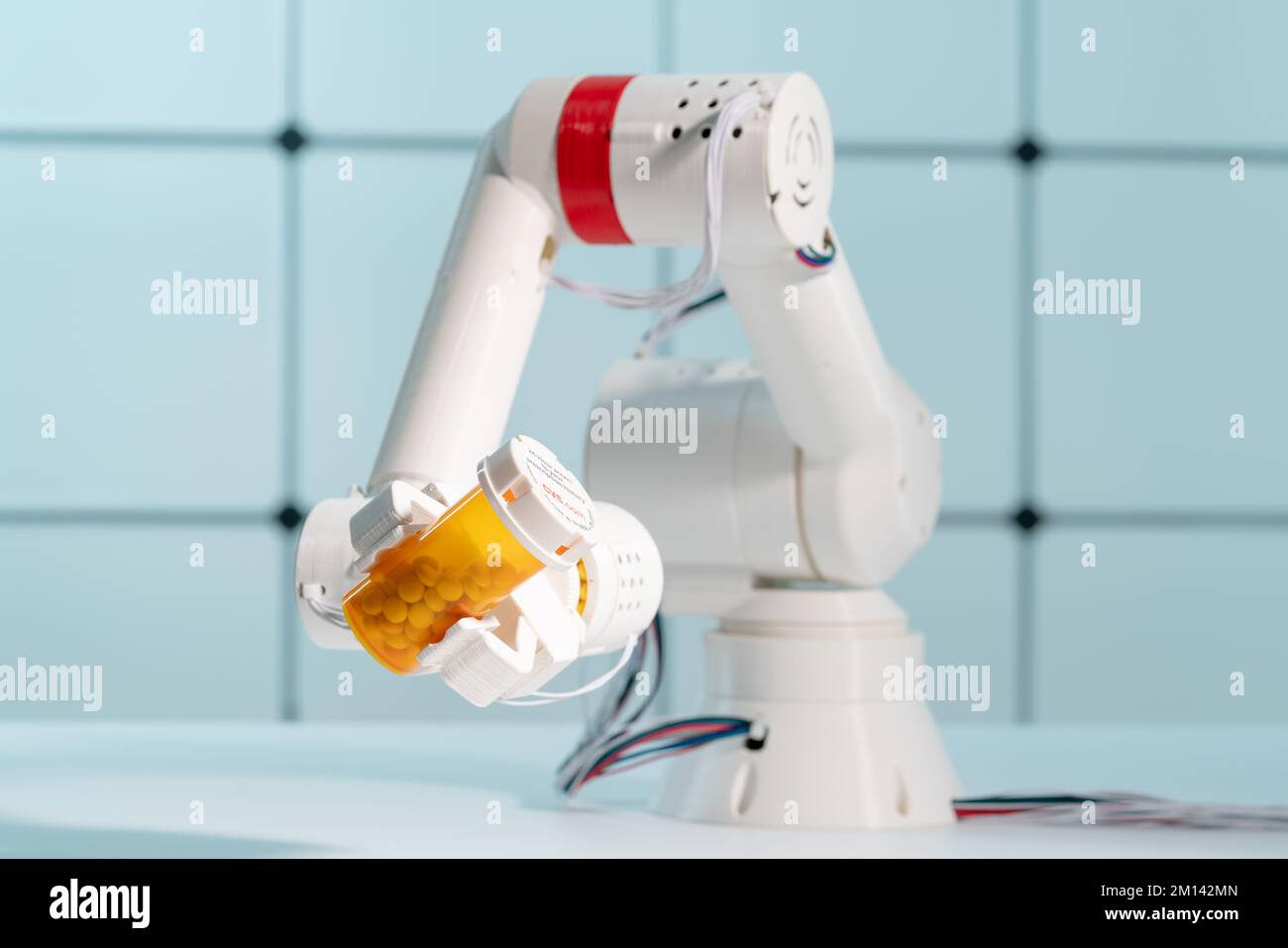 Robotic arm holding bottle of tablets Stock Photo - Alamy