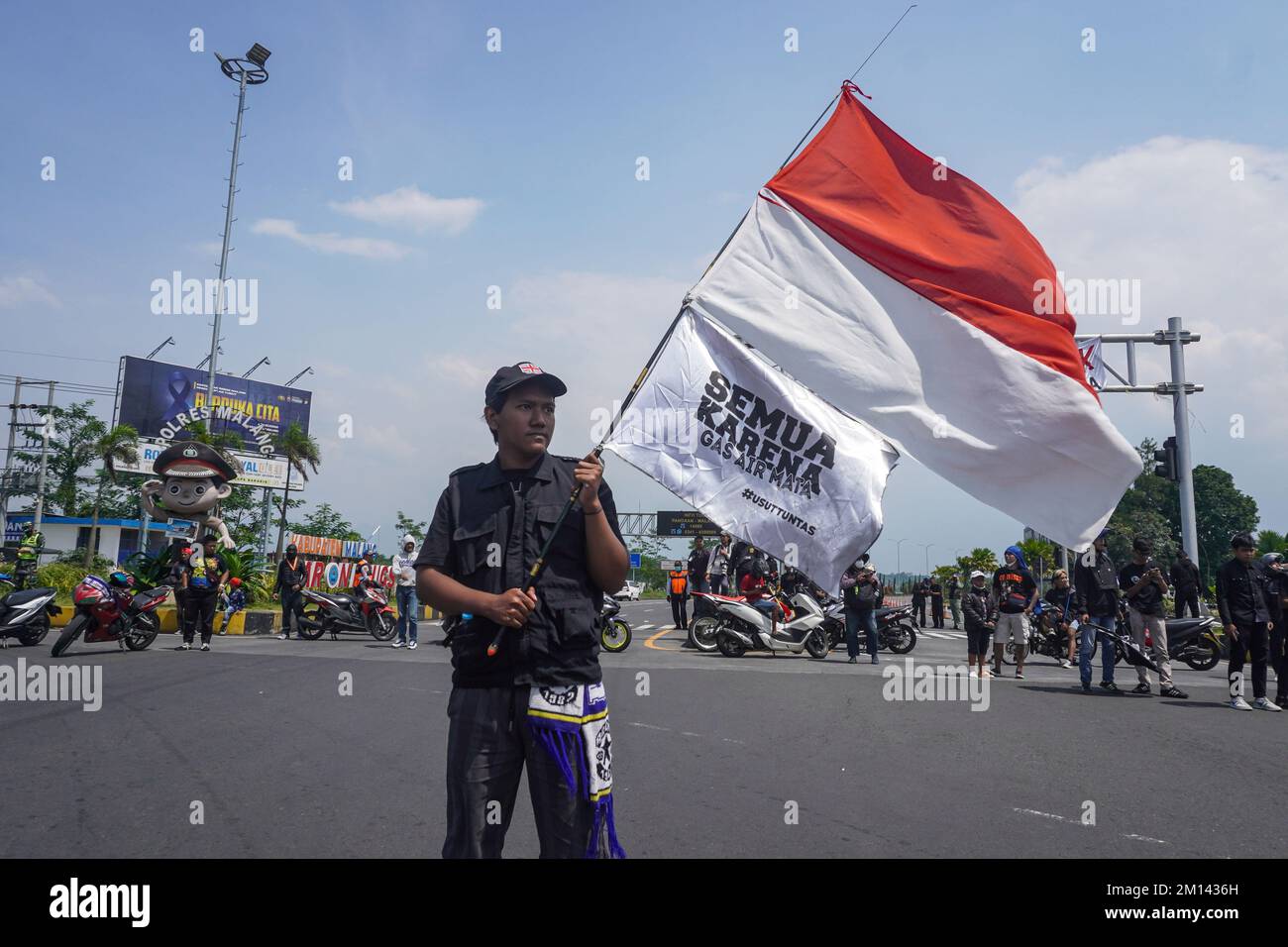 A demonstrator carries an Indonesian national flag of red and white ...