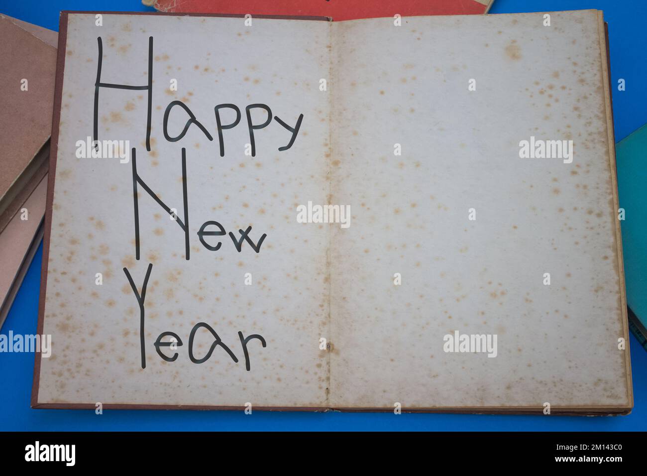 Happy New Year word in opened book with vintage, natural patterns old ...