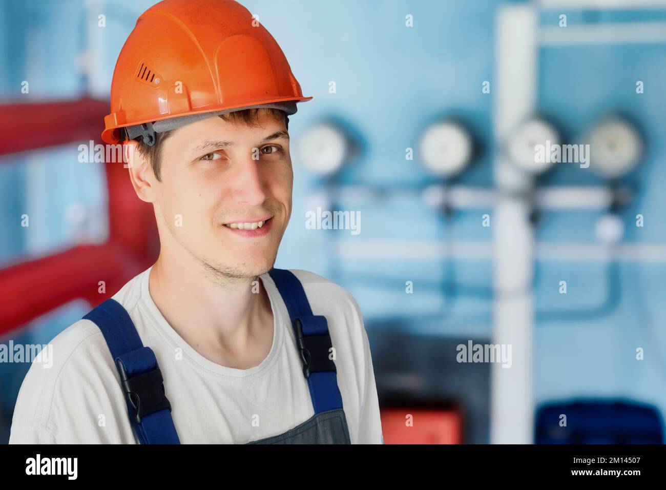 Male portrait of worker in construction helmet inside industrial ...