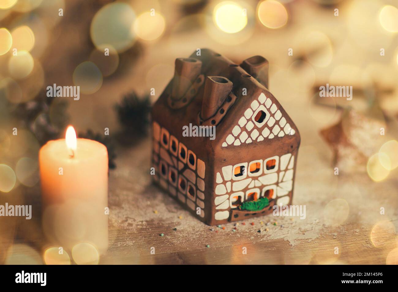 gingerbread house candle on blurred background of the table. beautiful ...