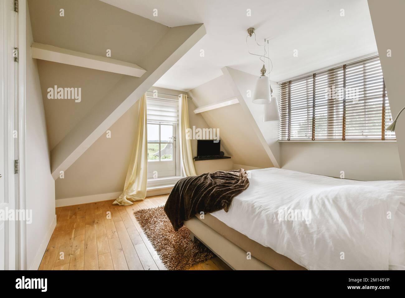 Home interior design of bedroom with bed and wooden wardrobe placed in ...