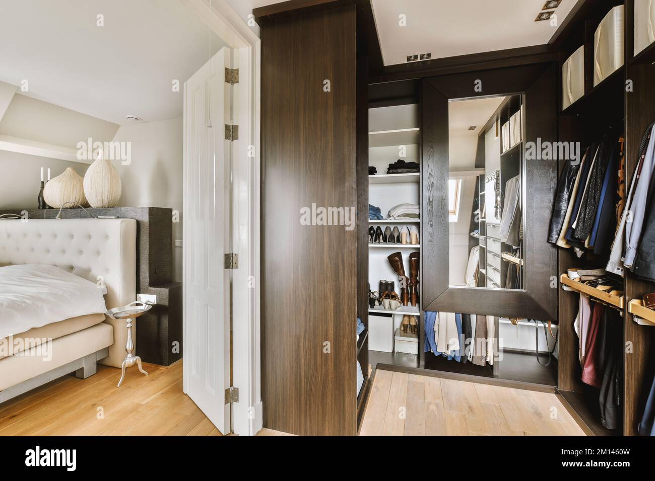 Home interior design of bedroom with bed and wooden wardrobe placed in ...