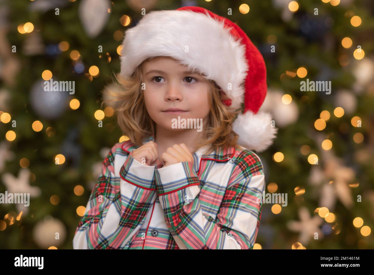 Kid praying, kids prayer. Happy funny child in Santa hat near Christmas ...