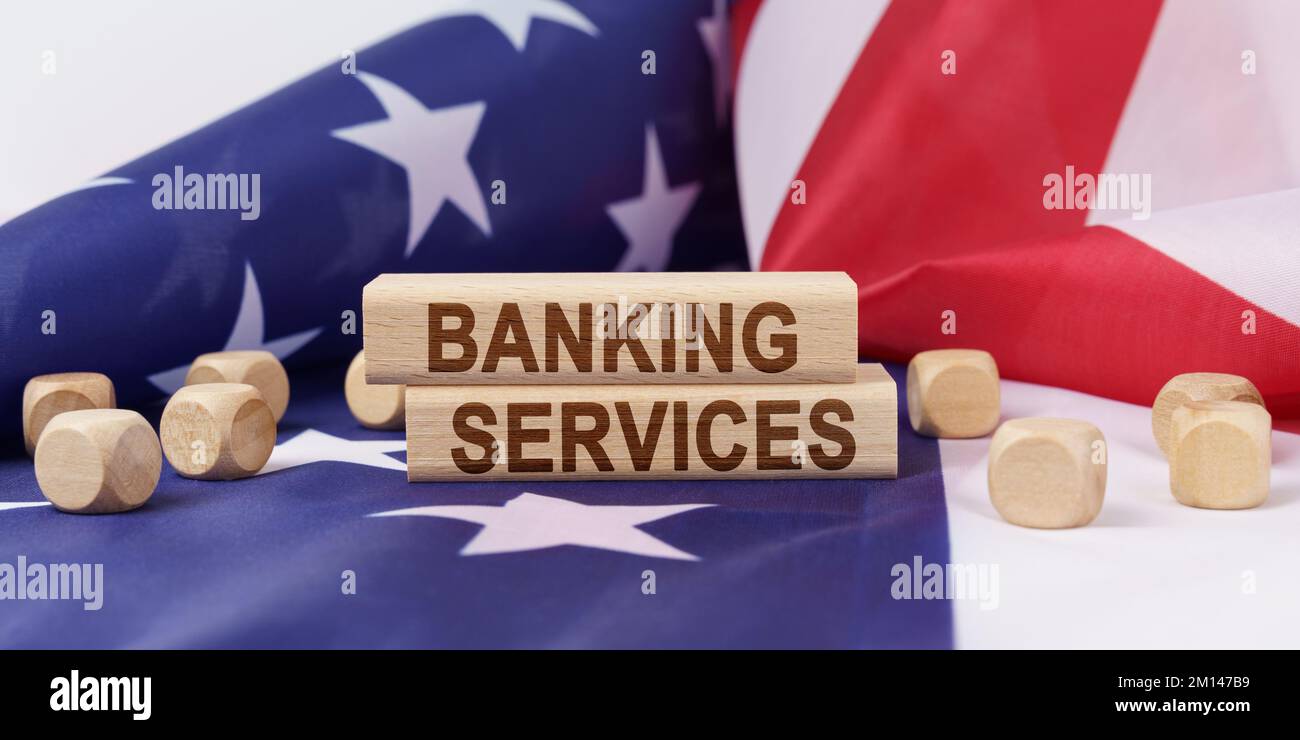 Business concept. The American flag has wooden cubes and plaques that ...