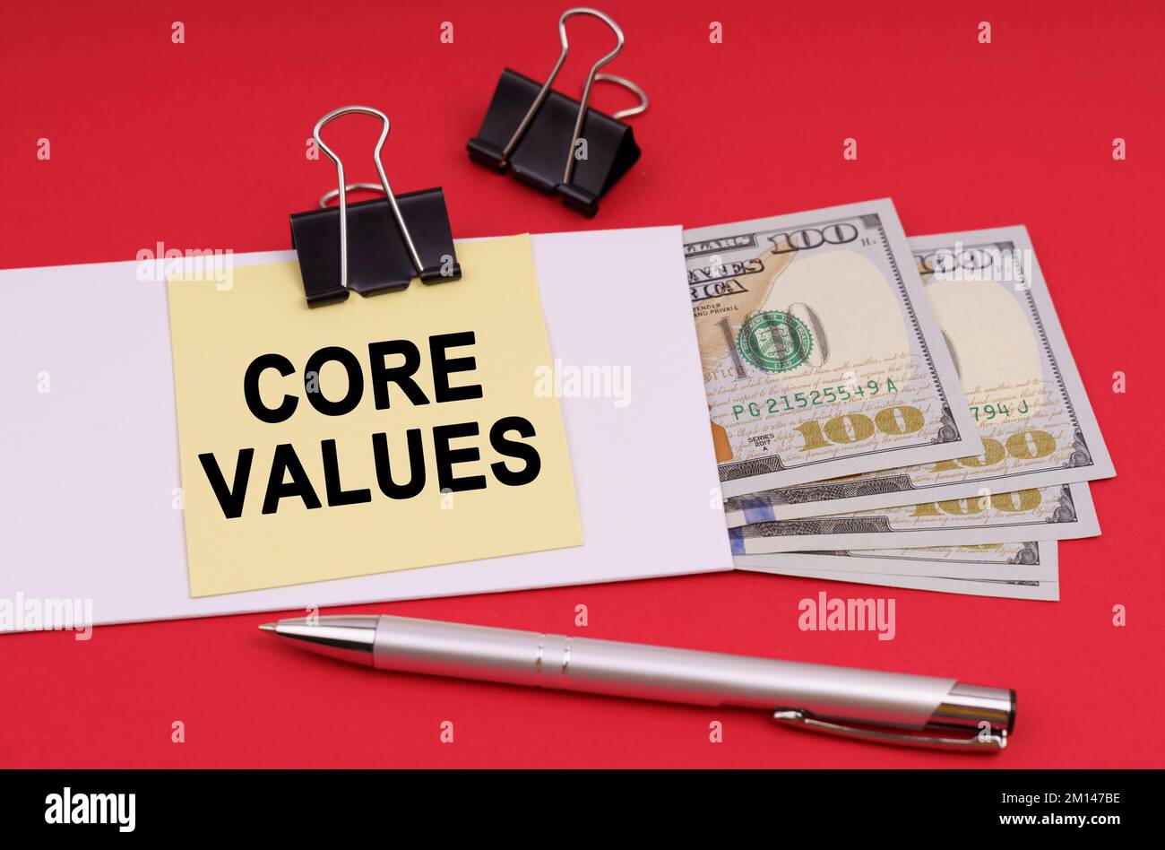 Business concept. On a red background, an envelope with money and a ...