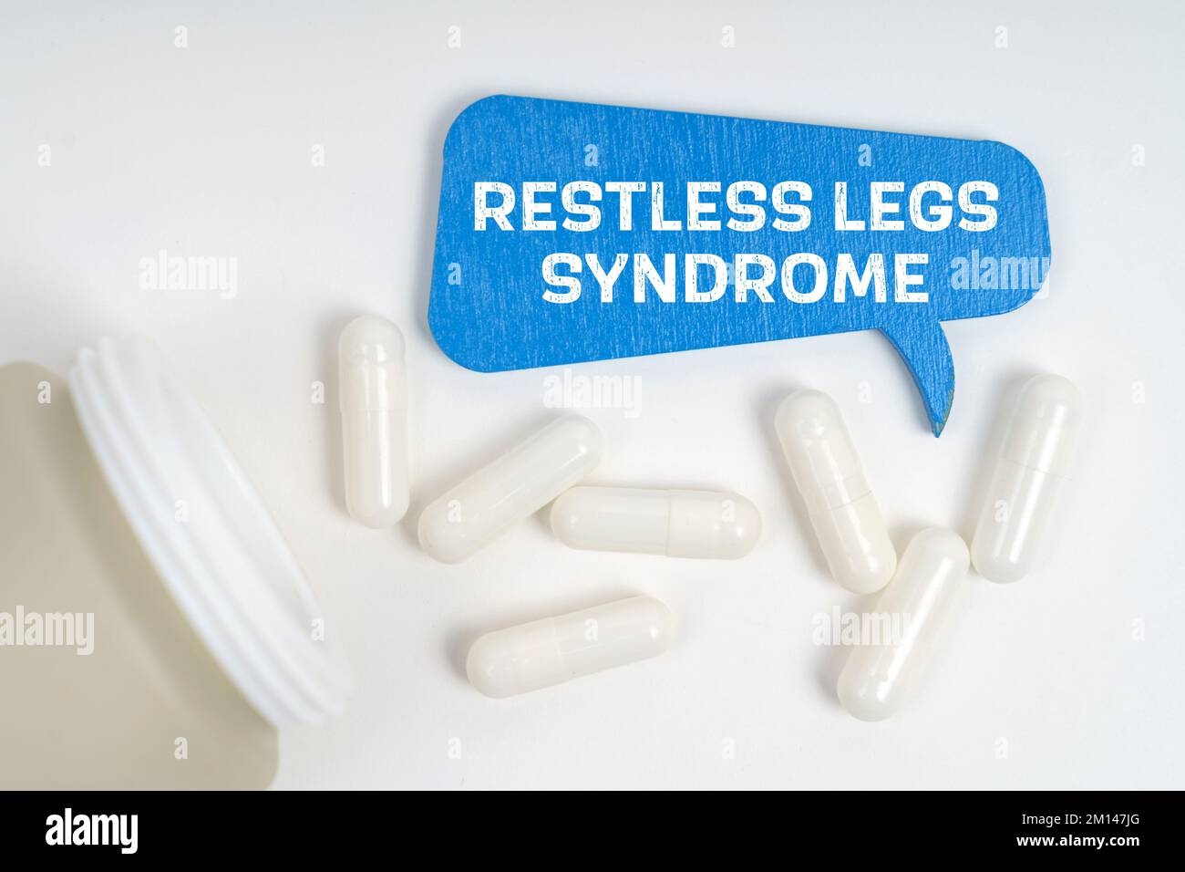 Medicine and health concept. On the table are pills and a blue sign ...