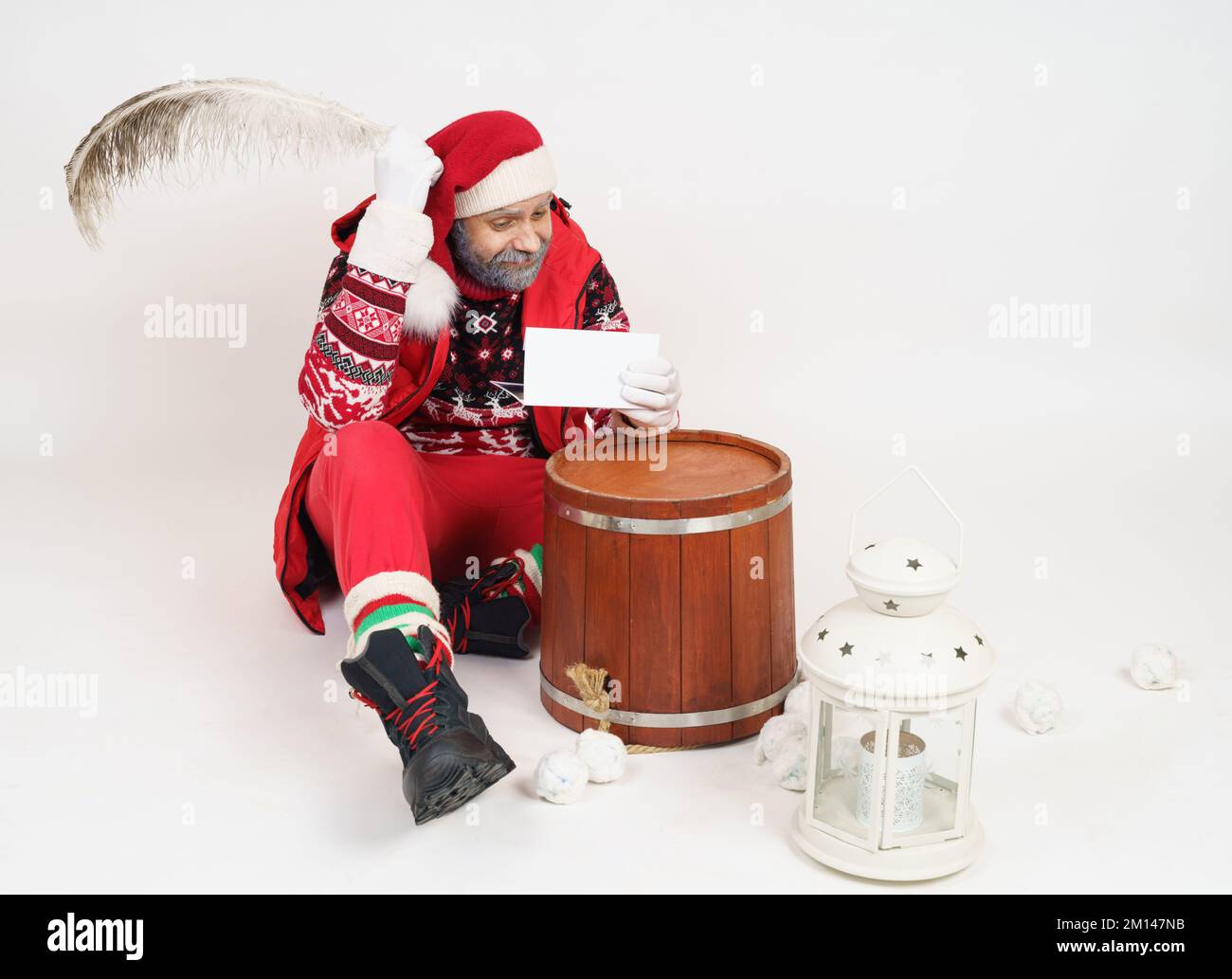 Holiday and Christmas concept. Santa Claus is sitting on the floor and ...