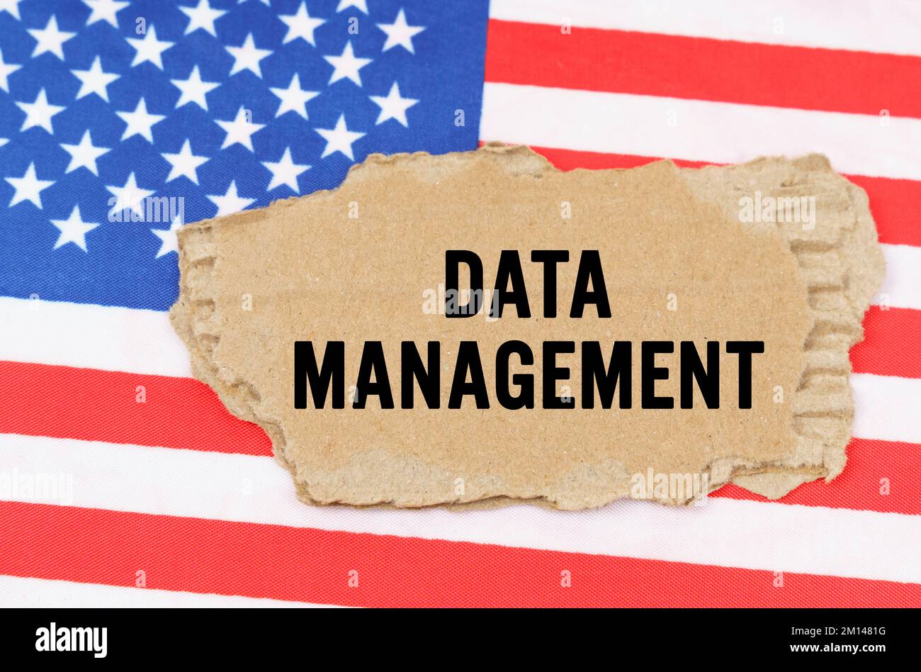 Business and finance concept. On the US flag lies a cardboard box with ...