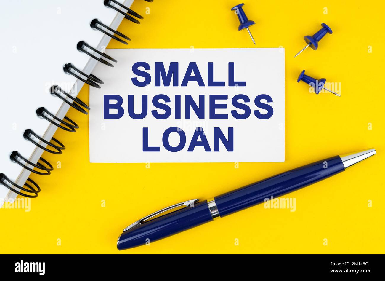 Business and finance concept. On a yellow background lies a notebook, a ...