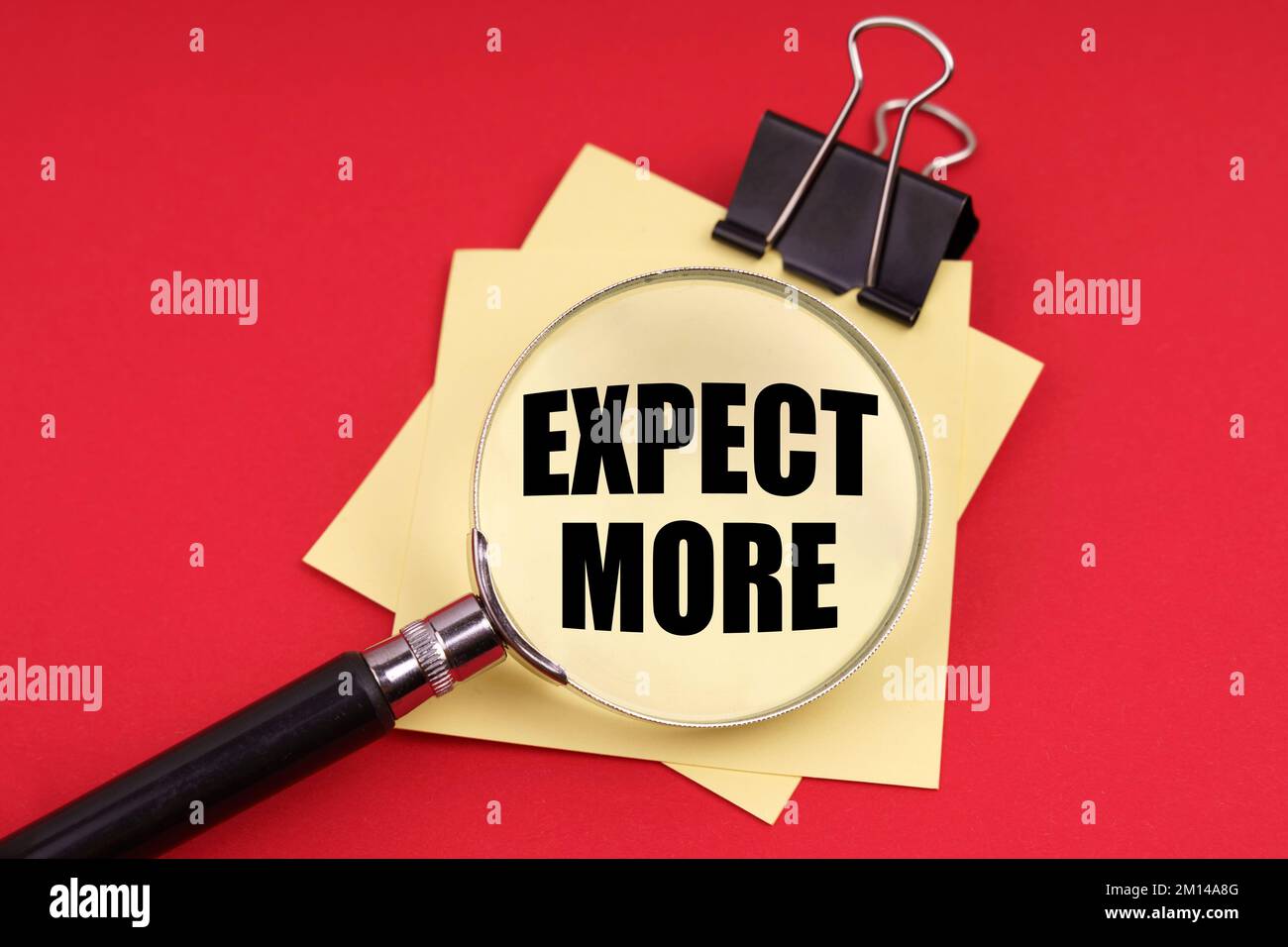 Business and Economics. On a red background, a magnifying glass and a ...