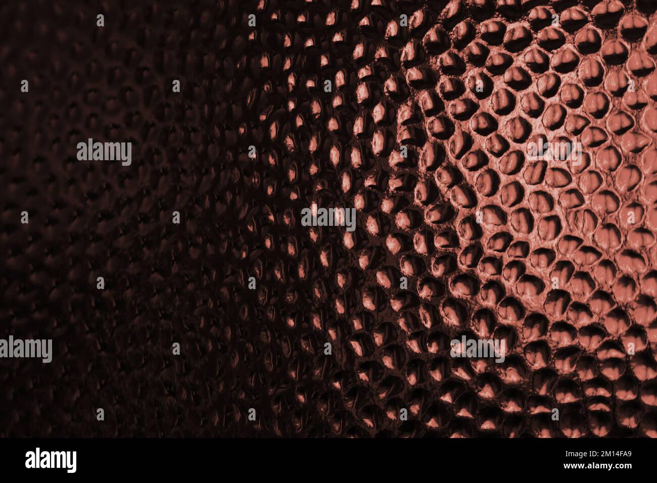 Shiny hammered copper textured surface. Orange and black color ...