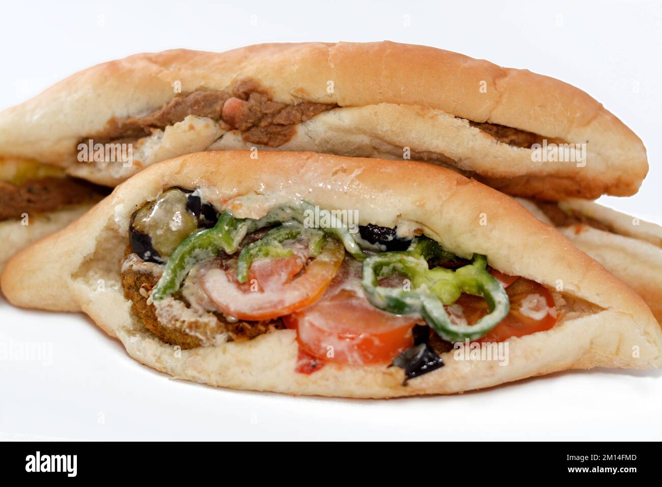 Pile of French Fino bun bread with popular Egyptian mashed fava beans ...