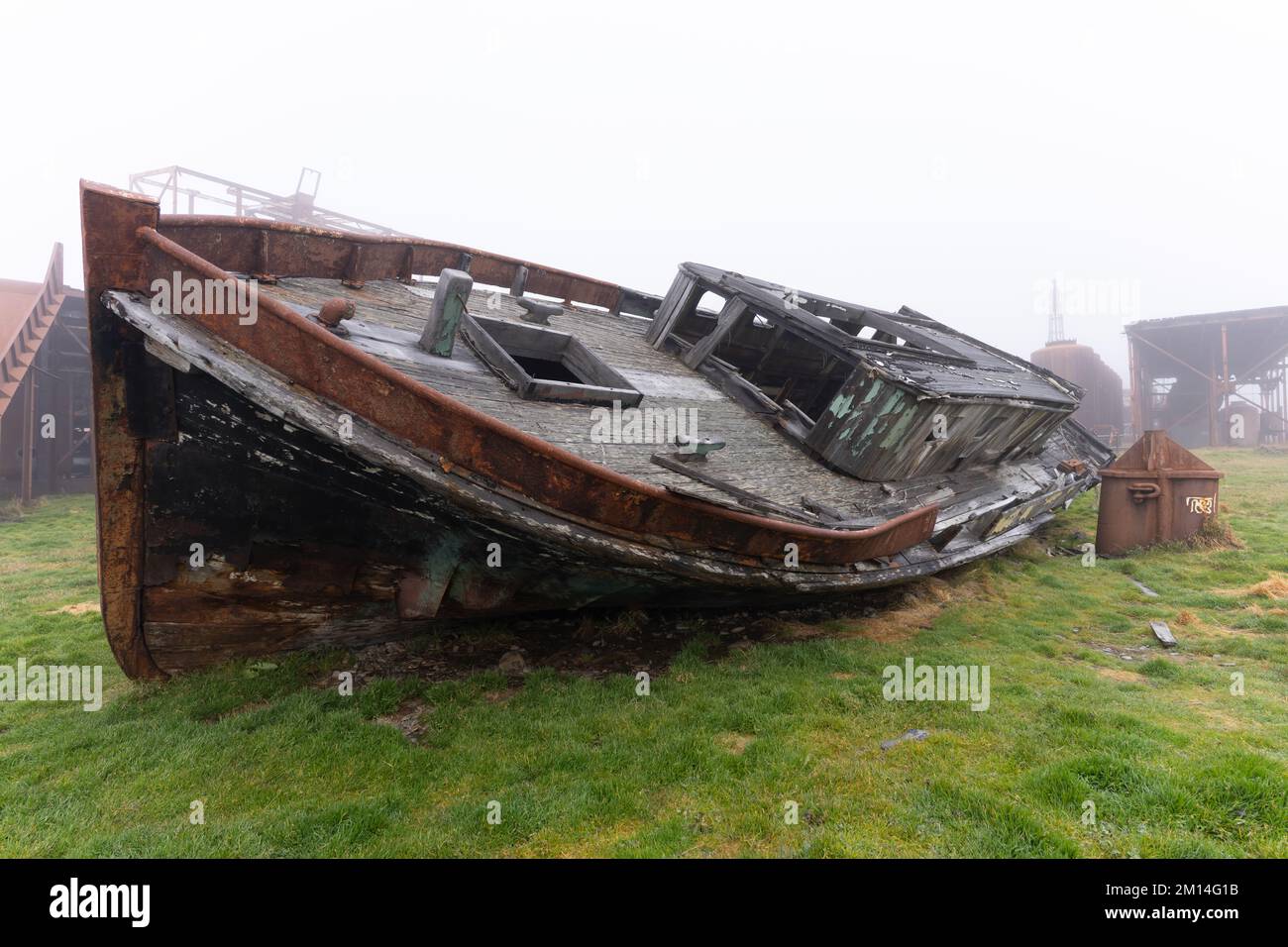 Old, rusty whaling ships and processing facilities at a now abandoned ...