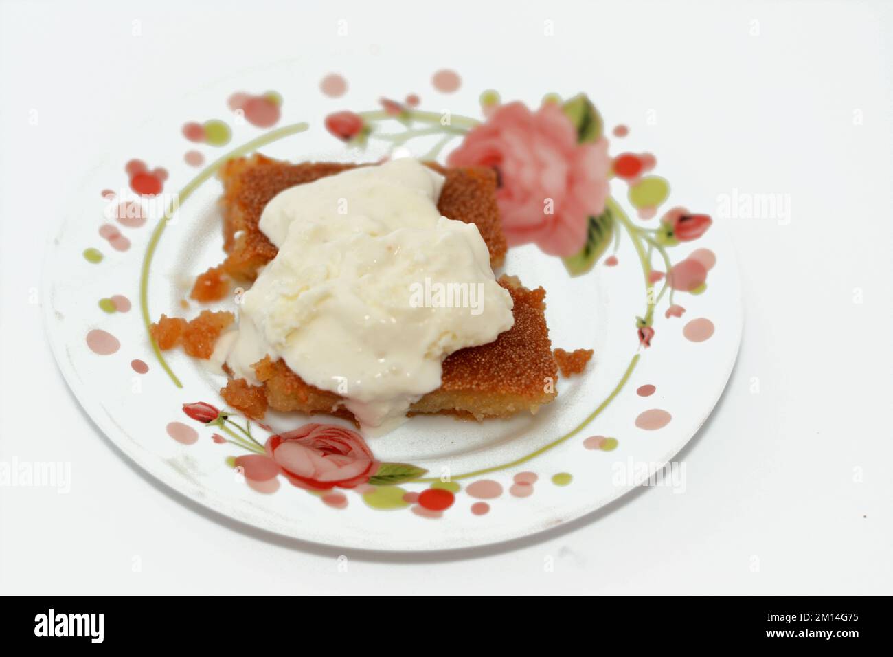 Basbosa with creamy qeshta on it and saturated with honey sugary syrup ...
