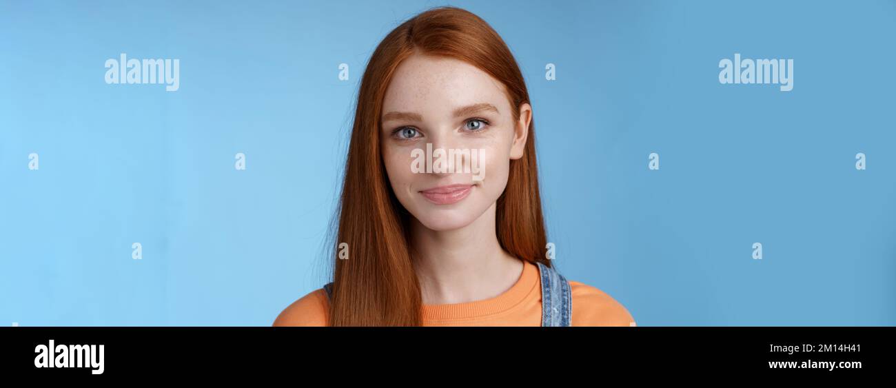 Outgoing young redhead girl blue eyes wearing orange t-shirt overalls ...